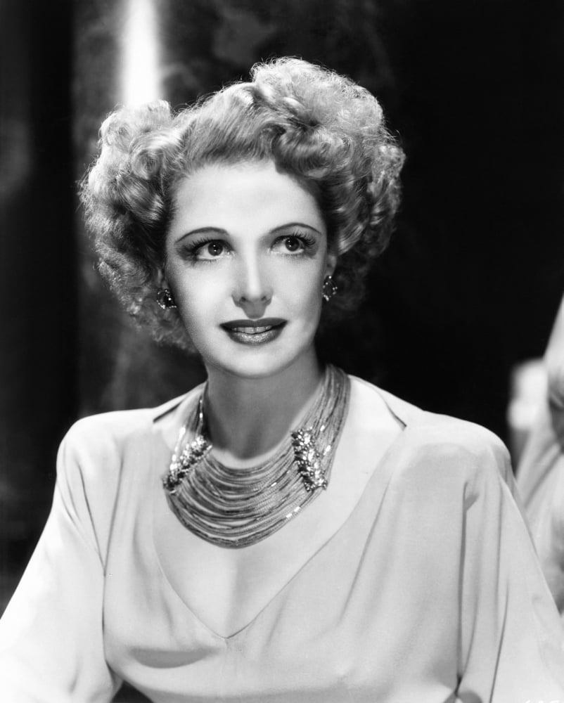 Natalie Schafer Modeling A Necklace Made Of Beige Fringe And Gold Beads ...