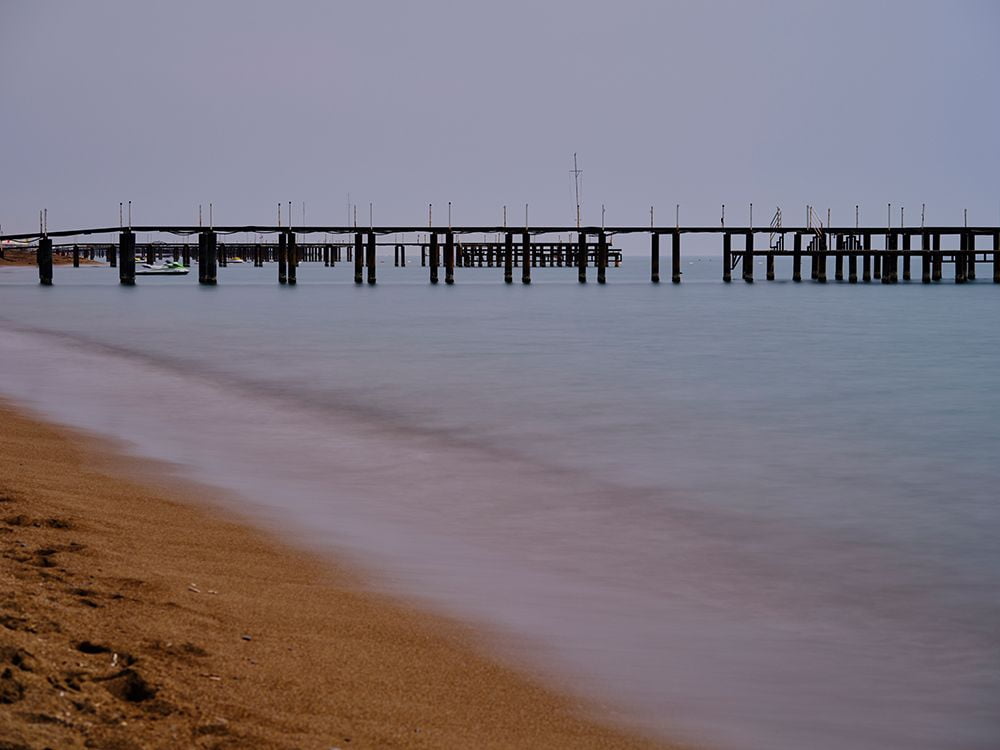 Old Pier On The Beach And Long Exposure Sea Waves Poster Print - Engin ...