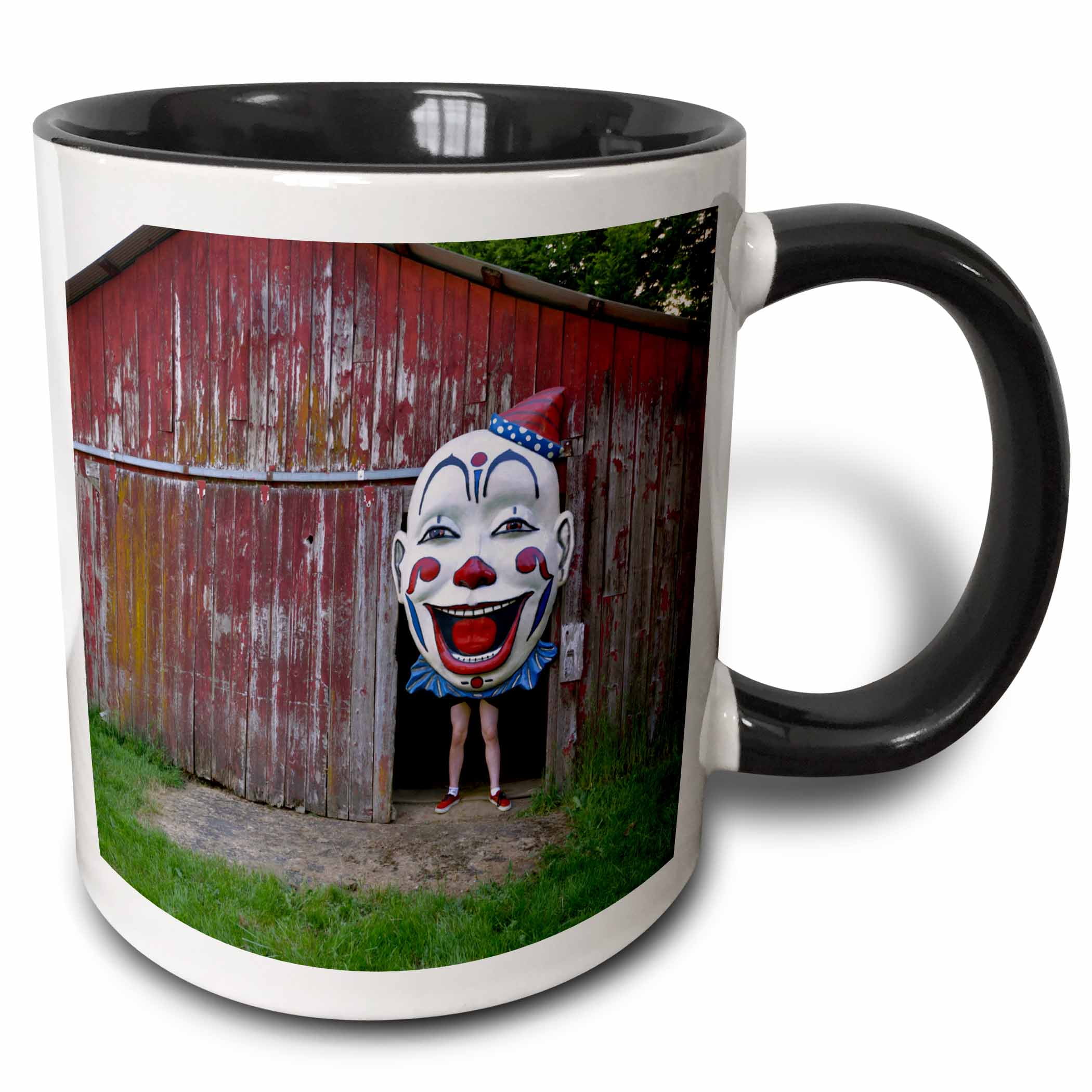 Oregon, Oregon City. Person holding clown face in door of red barn ...