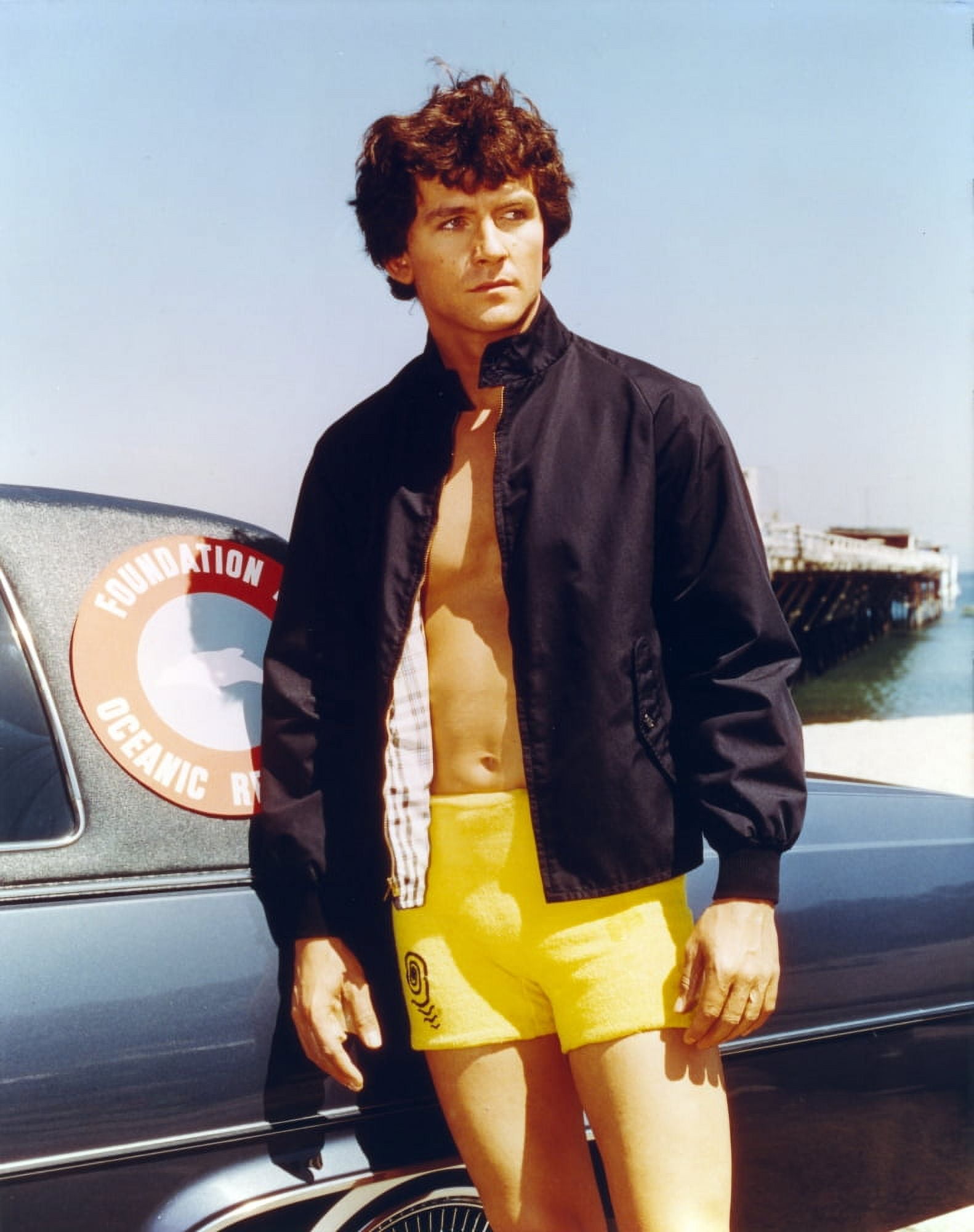 Patrick Duffy standing in Swimming Trunks with Black Jacket Photo Print ...