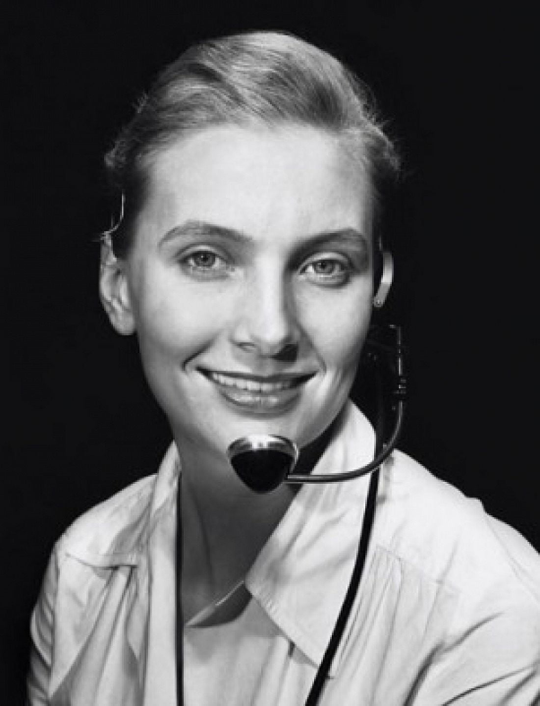 Portrait of a female customer service representative wearing a headset ...