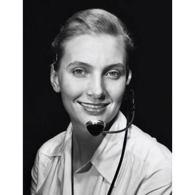 Portrait of a female customer service representative wearing a headset ...