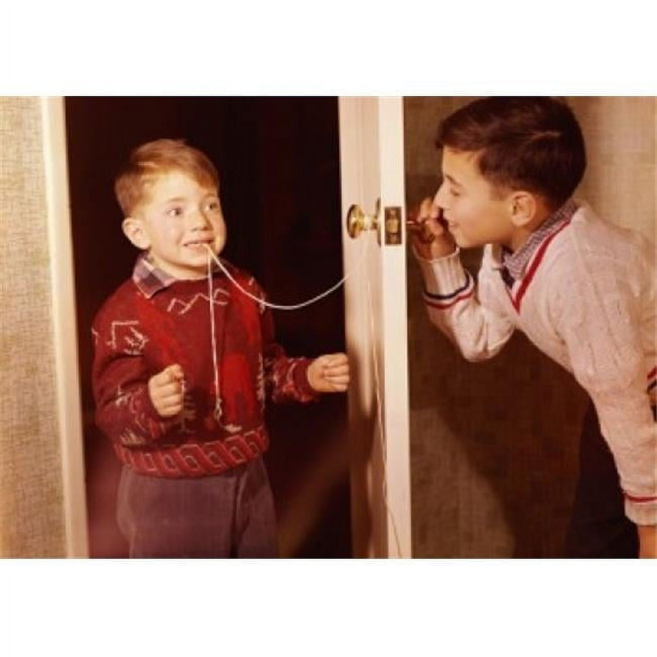 Posterazzi Boy Attempting to Extract His Brothers Loose Tooth Using ...