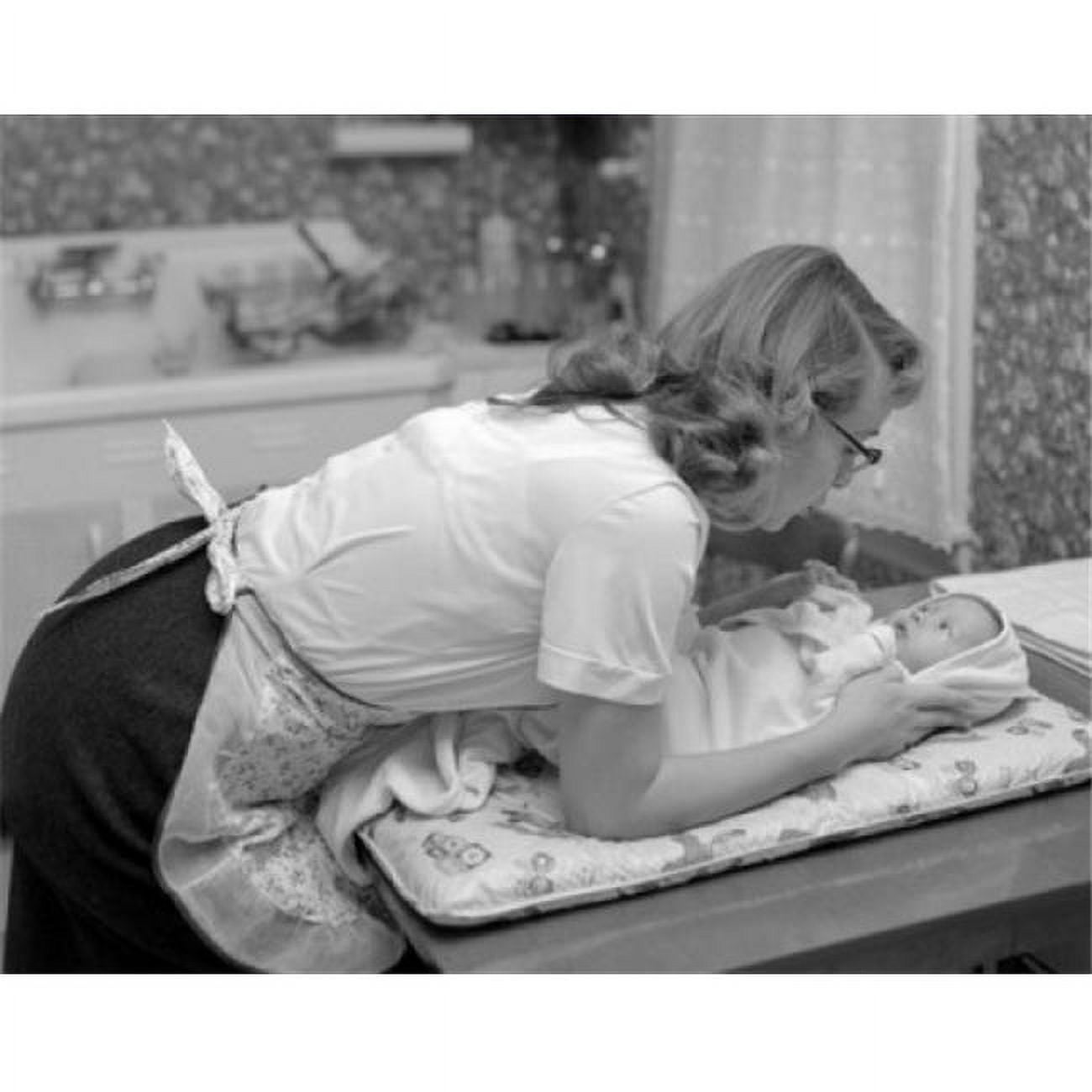 Posterazzi SAL2559812 Mother Bending Over Baby Lying on Changing Mat ...