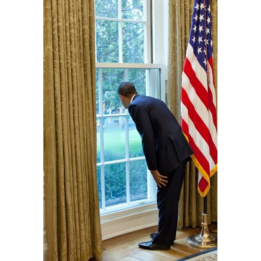 President Barack Obama Looks Out A Window In The Oval Office To See ...