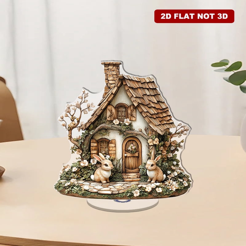 Revolving acrylic display featuring a detailed wooden cottage with ...