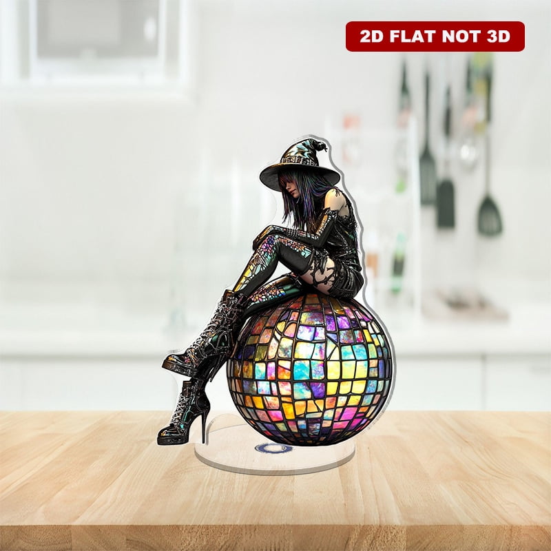 Revolving acrylic ornament featuring a punk witch in black boots on a ...