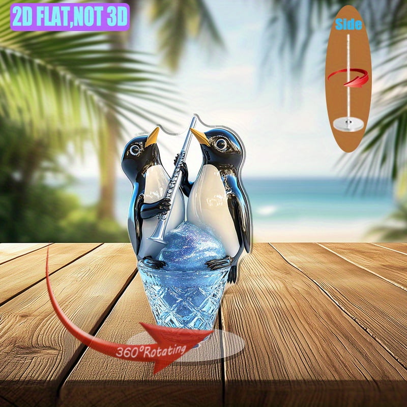 Revolving acrylic ornament featuring two penguins playing flutes atop a ...