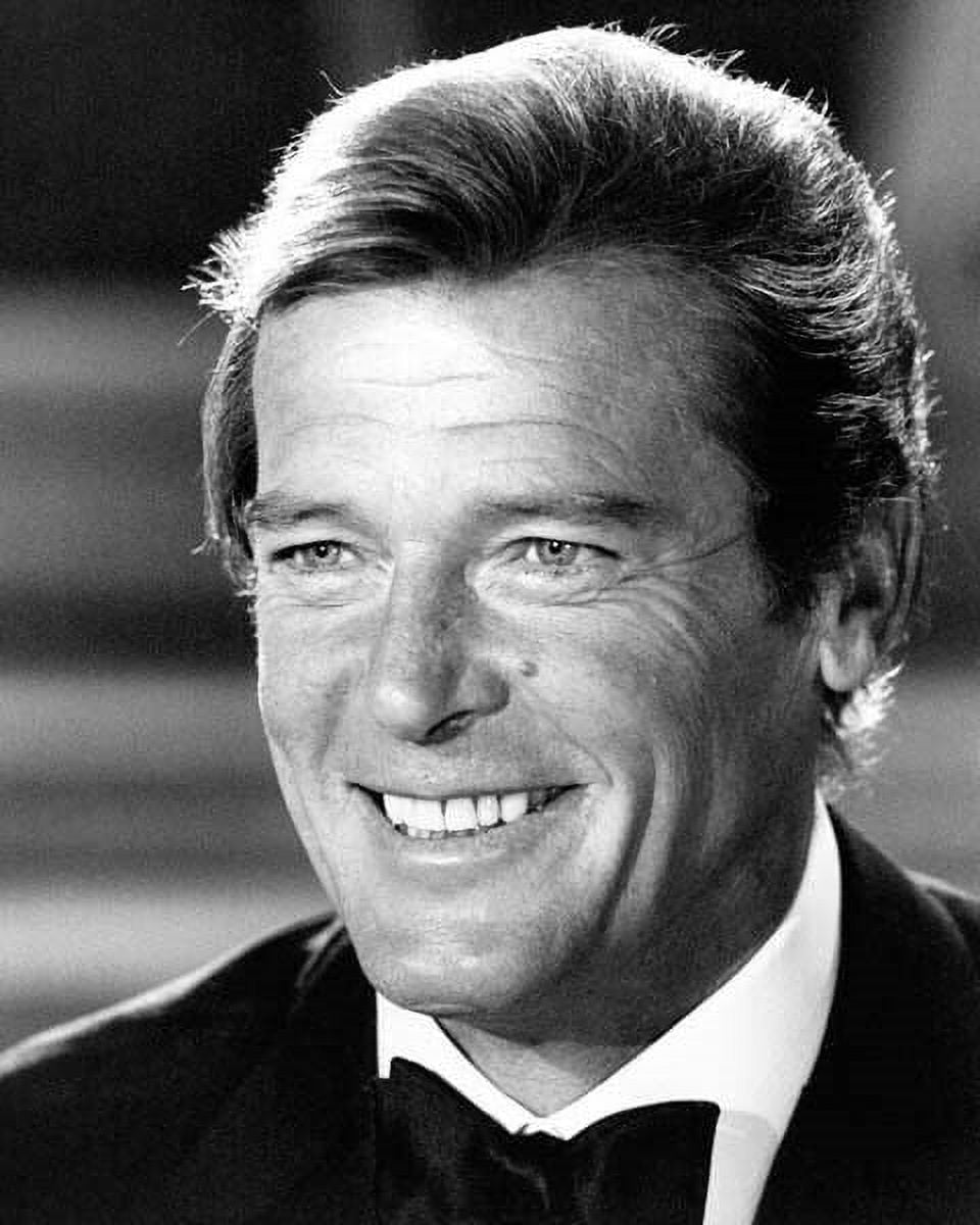 Roger Moore gives his debonair roguish smile as James Bond in tuxedo ...