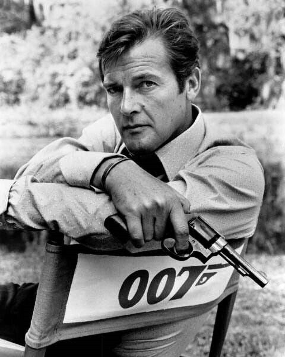 Roger Moore on Live and Let Die set in 007 chair holding gun 8x10 inch ...