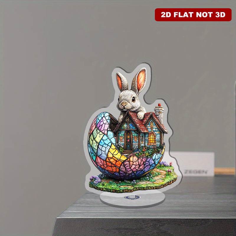 Rotating acrylic display features a bunny before a stained glass house ...