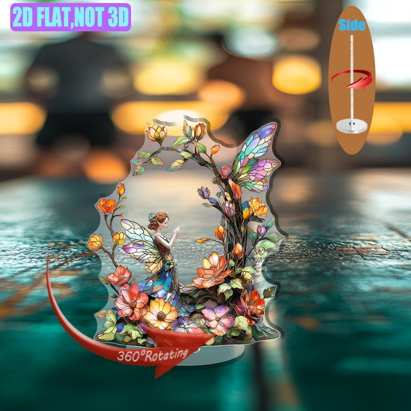 Rotating acrylic display features a fairy garden floral chocolate cascade with translucent wings ...