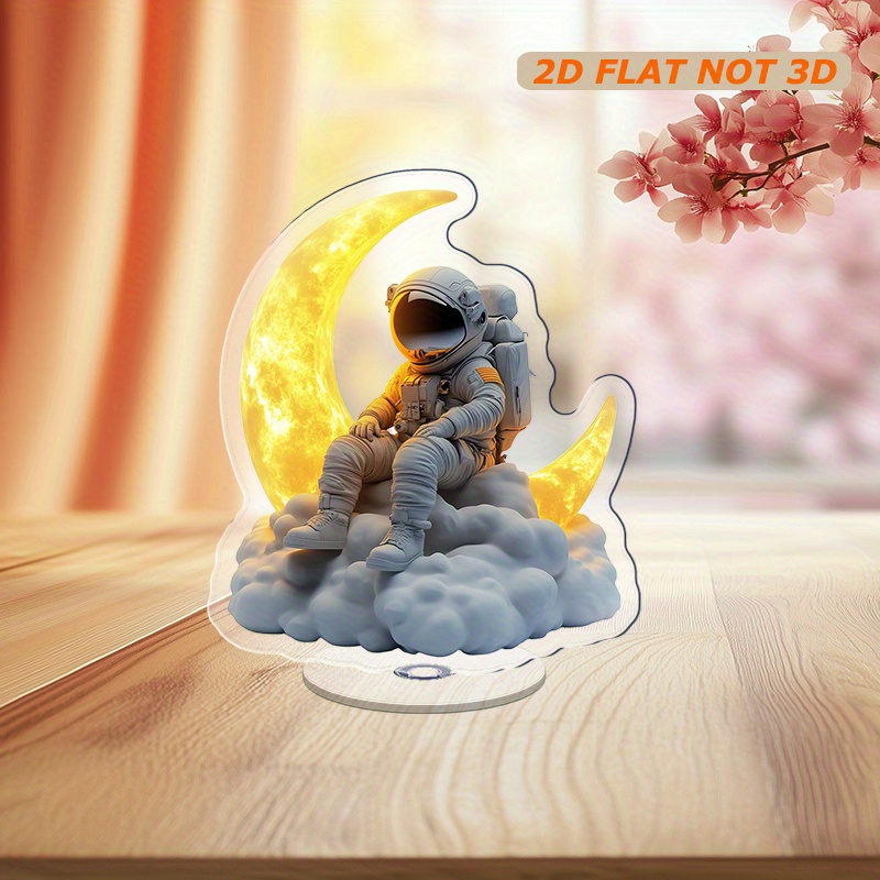 Rotating acrylic display featuring an astronaut on a glowing crescent ...