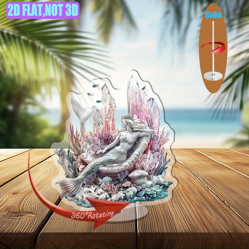 Rotating acrylic display featuring a silver mermaid on a shimmering ...