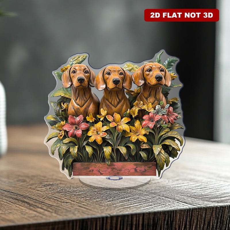 Rotating acrylic display featuring three rubber dogs in flowers on a ...
