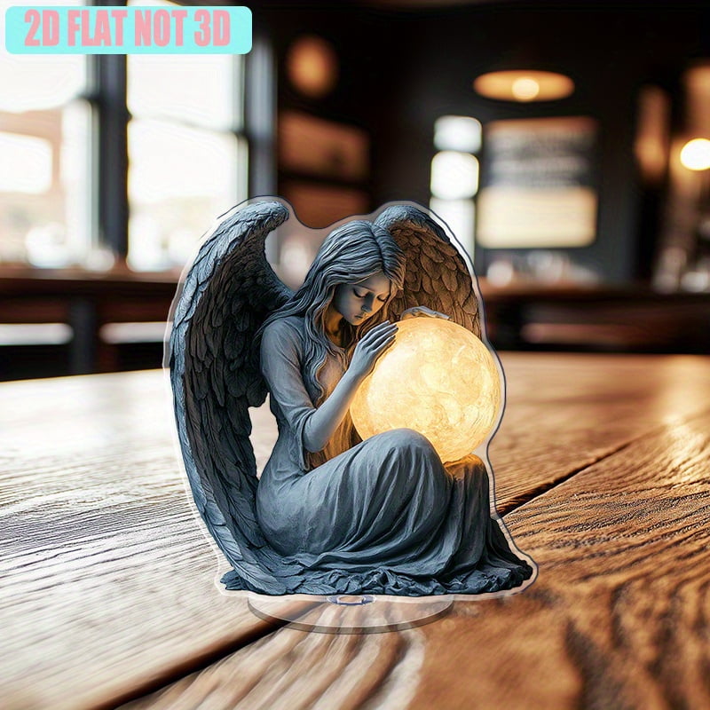 Rotating acrylic figurine of a solemn angel with large wings holding a ...