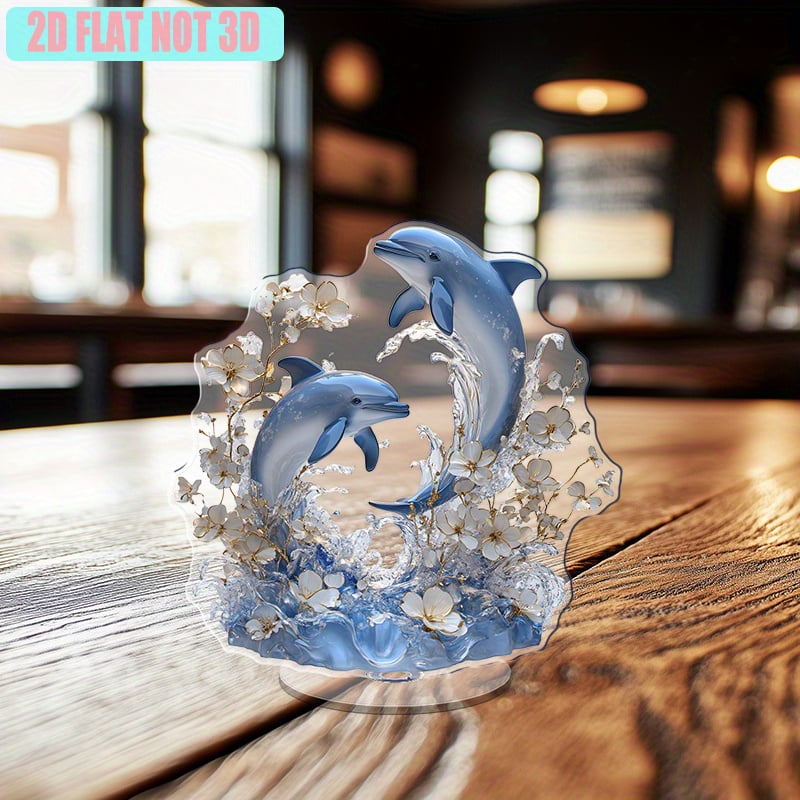 Rotating acrylic ornament features a blue and gold dolphin sculpture ...