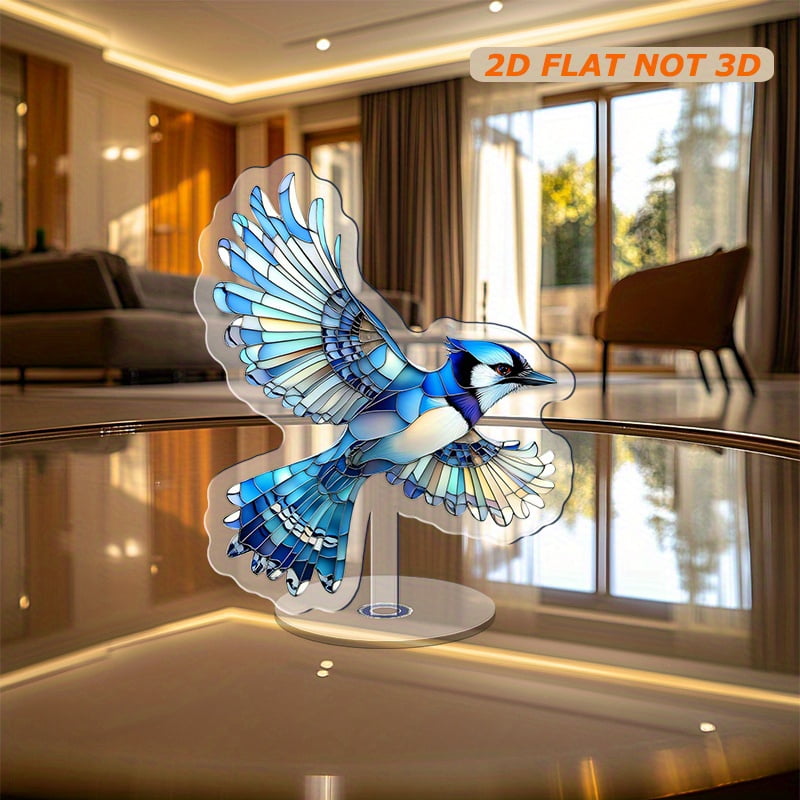 Rotating acrylic ornament featuring a blue jay in flight with delicate ...