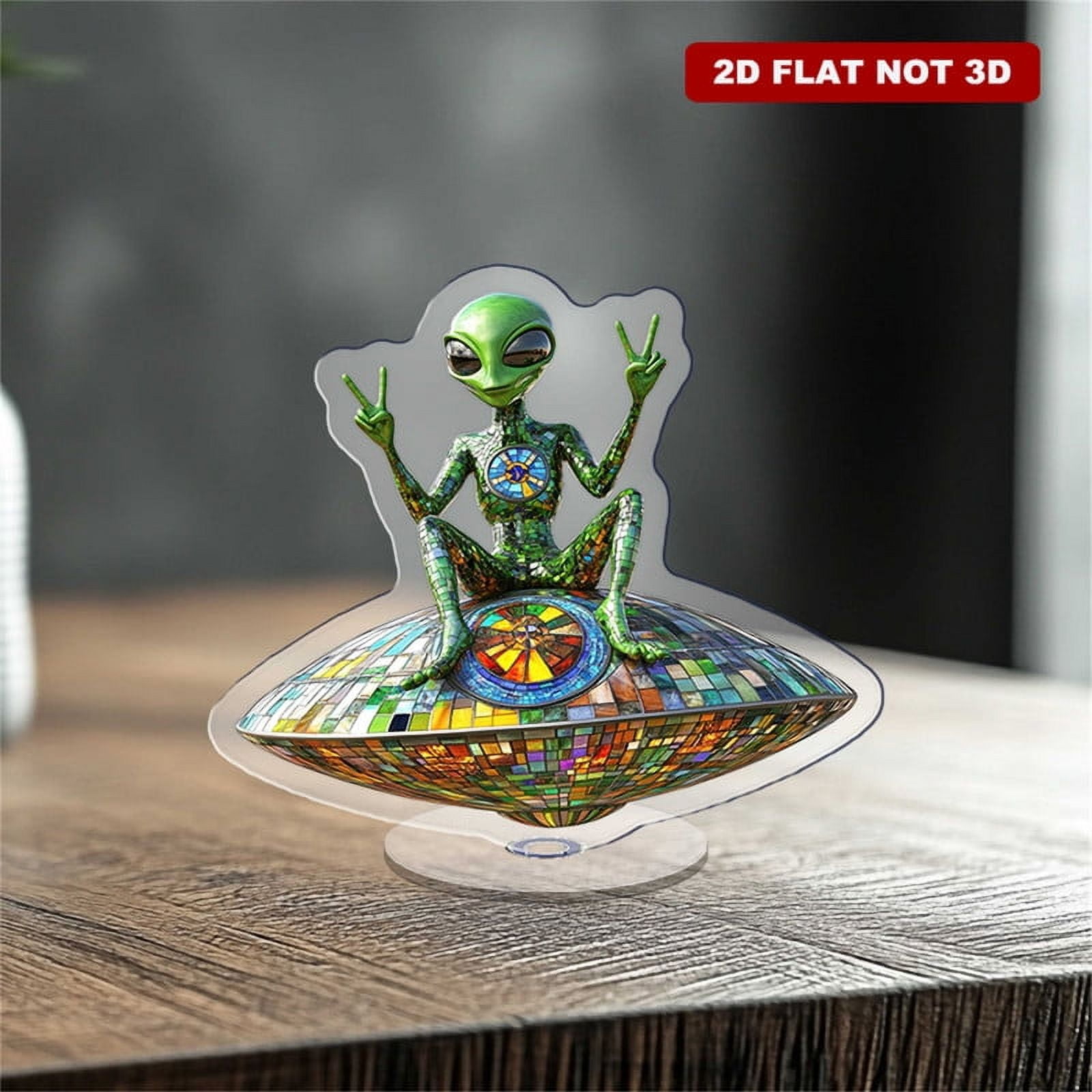 Rotating acrylic ornament featuring a green alien on a UFO making peace ...