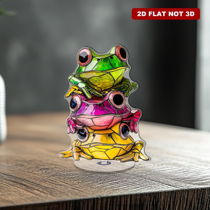 Rotating acrylic ornament featuring a stack of vibrant frogs in pink ...