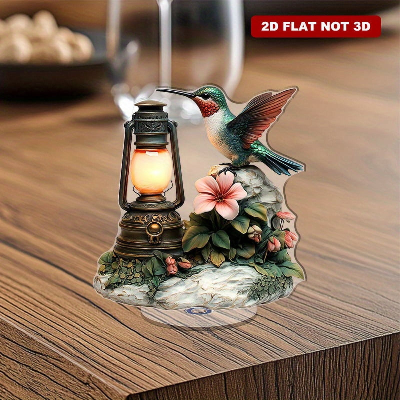 Rotating acrylic ornament featuring a vibrant hummingbird on a faux ...