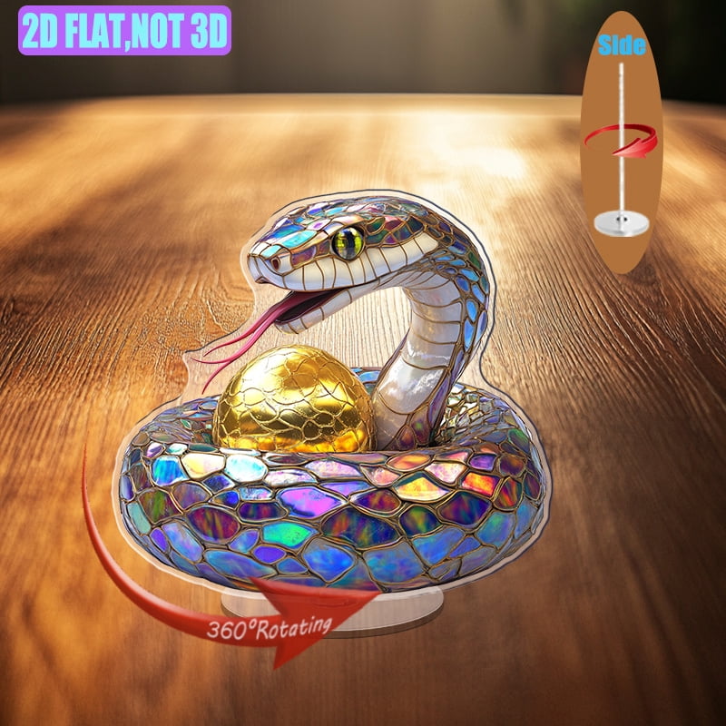 Rotating acrylic ornament featuring a vibrant snake wrapped around a golden egg with vivid eyes ...
