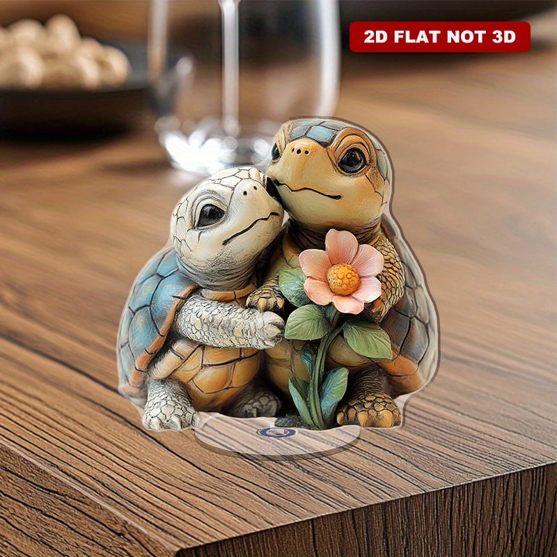 Rotating acrylic ornament featuring a whimsical turtle couple on a ...