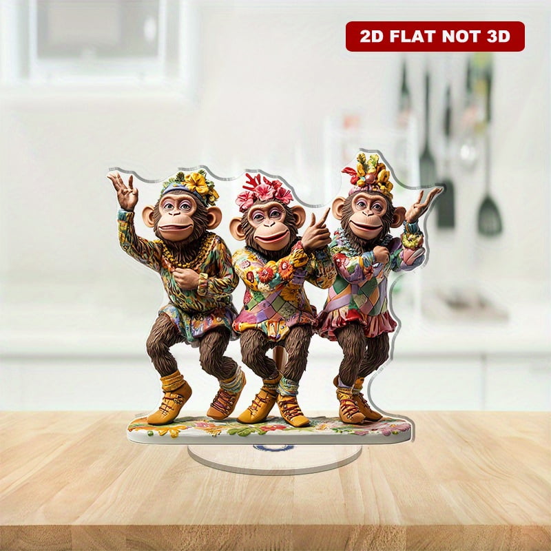 Rotating acrylic ornament featuring three vividly costumed monkeys on a ...