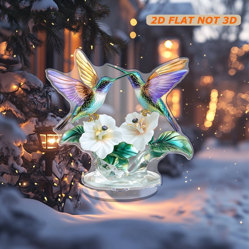 Rotating acrylic ornament featuring two vibrant hummingbirds on ...