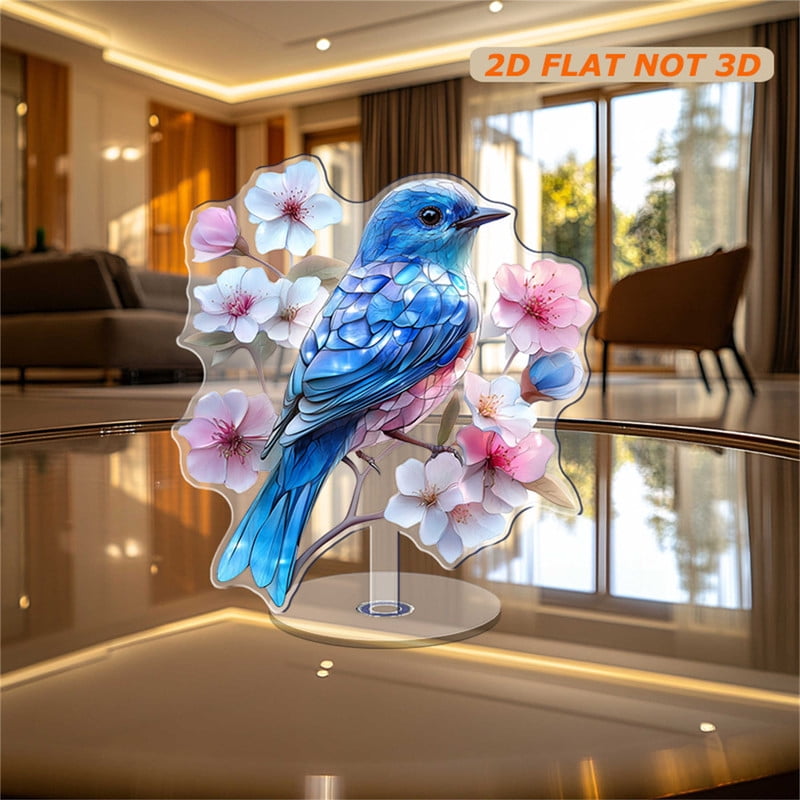 Rotating acrylic ornament featuring a vibrant blue bird amidst soft ...