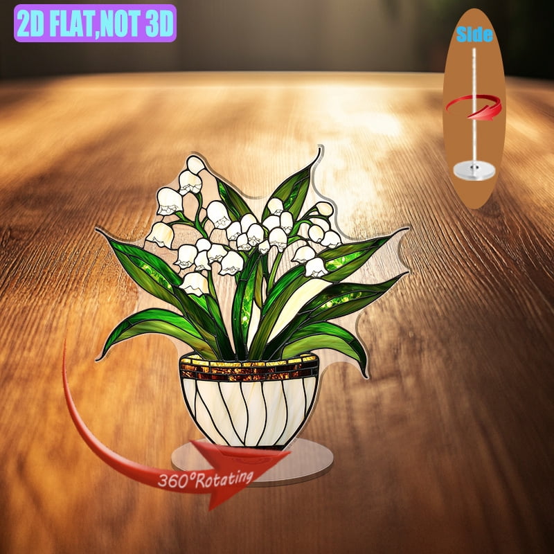 Rotating acrylic ornament featuring a white potted blooming Lily-of-the ...