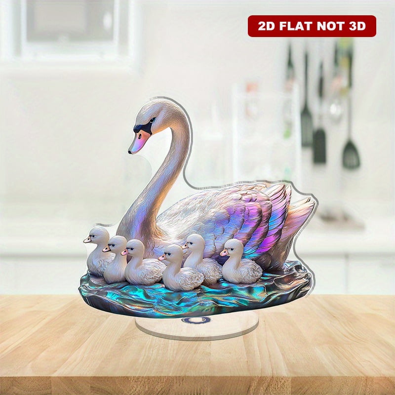 Rotating acrylic sculpture features a graceful swan and cygnets with ...