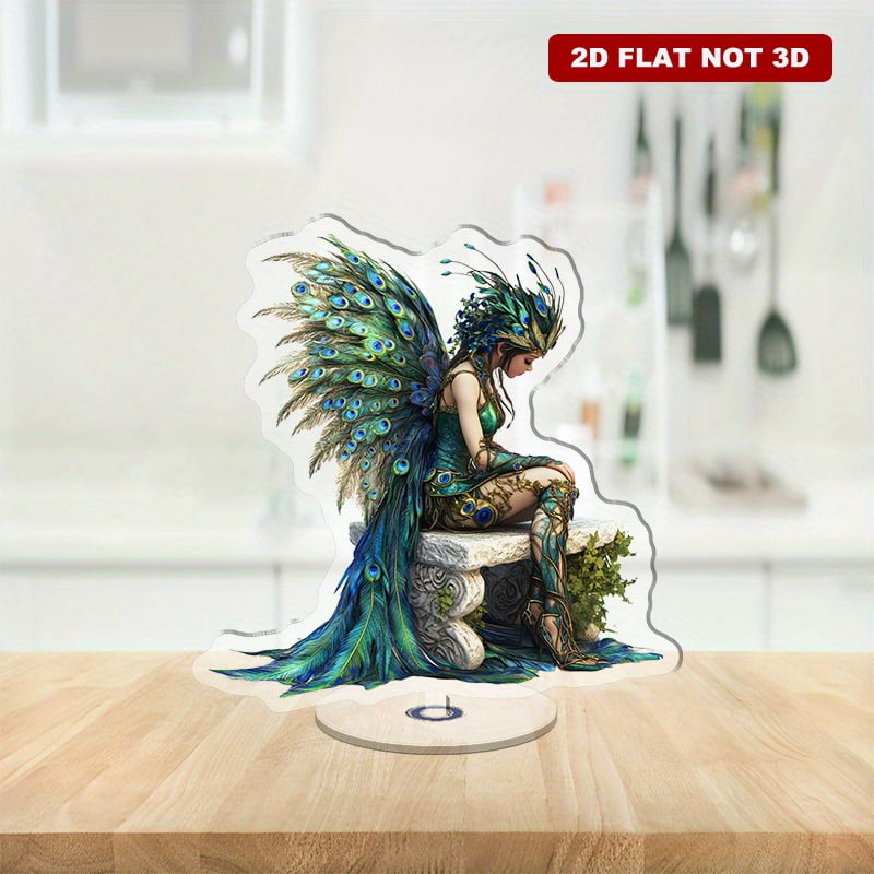Rotating acrylic sculpture features a peacock fairy with blue and green feather wings sitting on ...