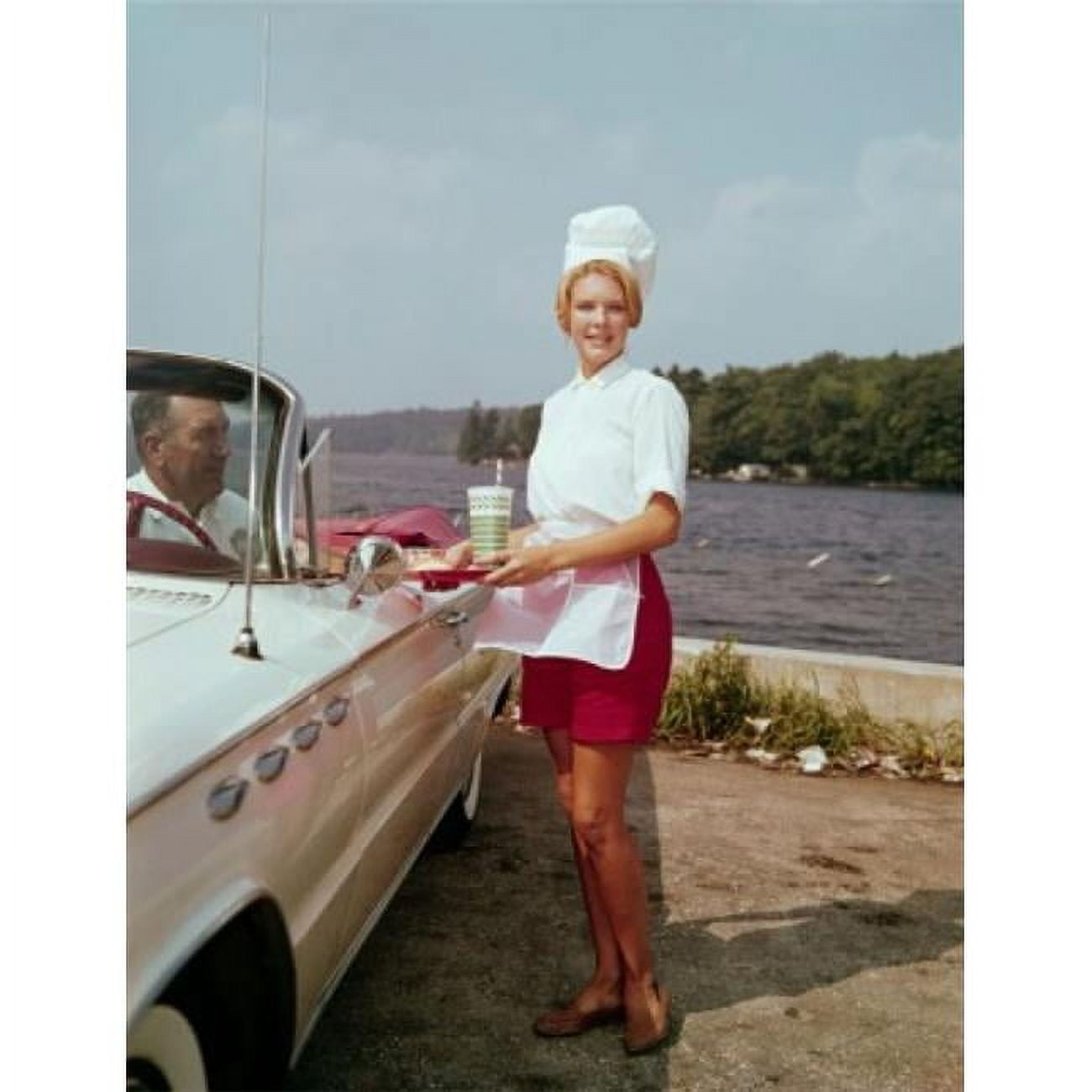 Side Profile of a Waitress Serving Food to a Mature Man Sitting in a ...