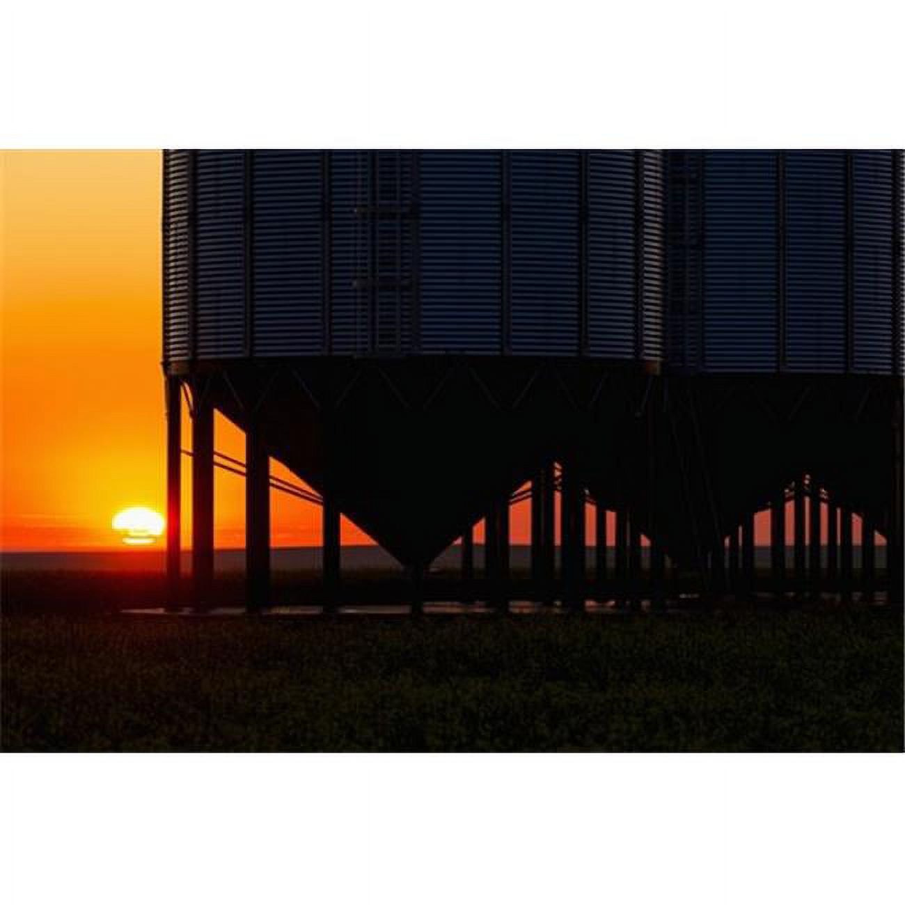 Silhouette of A Row of Large Metal Grain Bins with The Sunrise in The ...