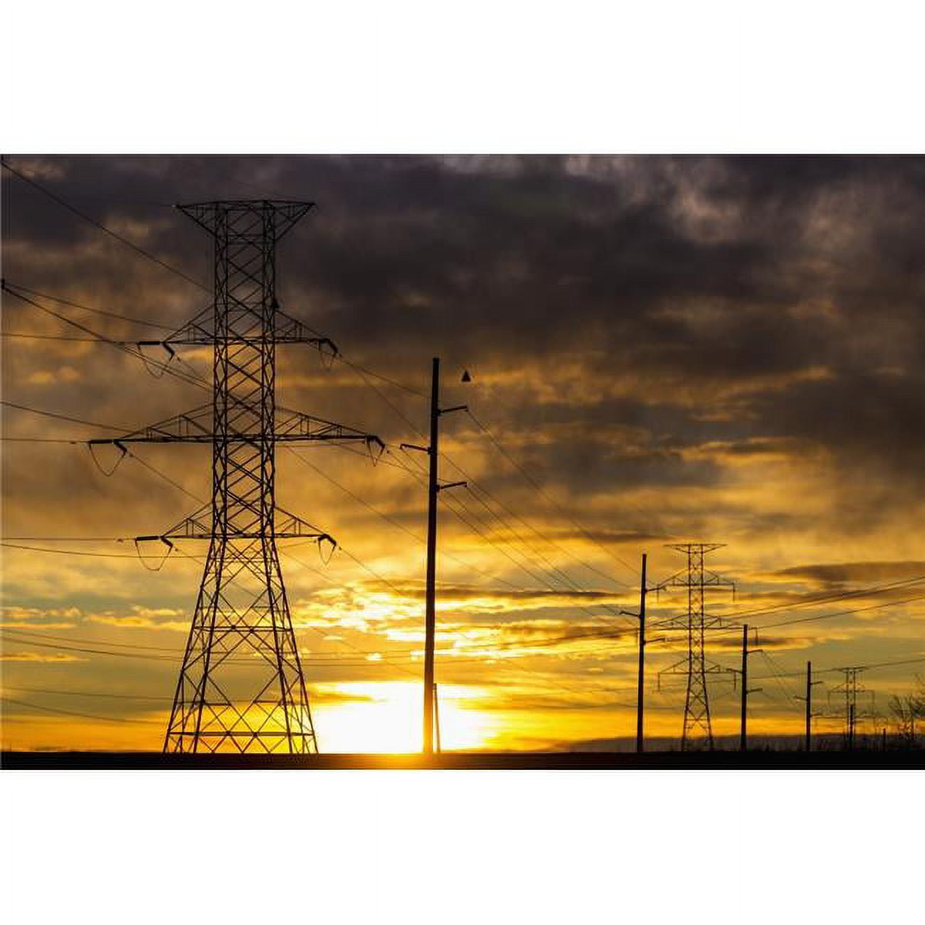 Silhouette of large metal powerline towers with colourful clouds and ...
