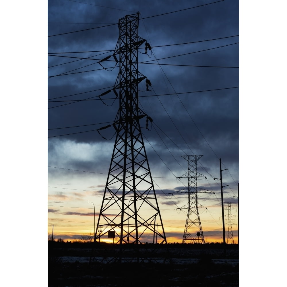 Silhouette of large metal powerline towers with glowing sky; Calgary ...