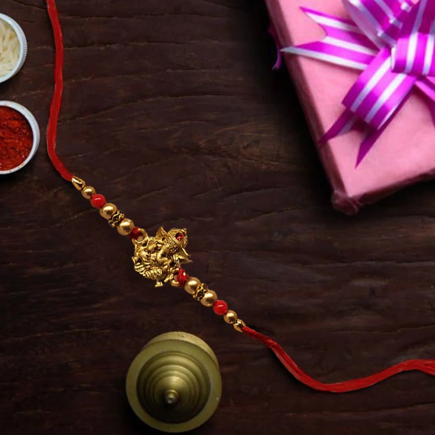Singhcart Golden Finish Ganesh Ji Rakhi With Red Thread for brother ...