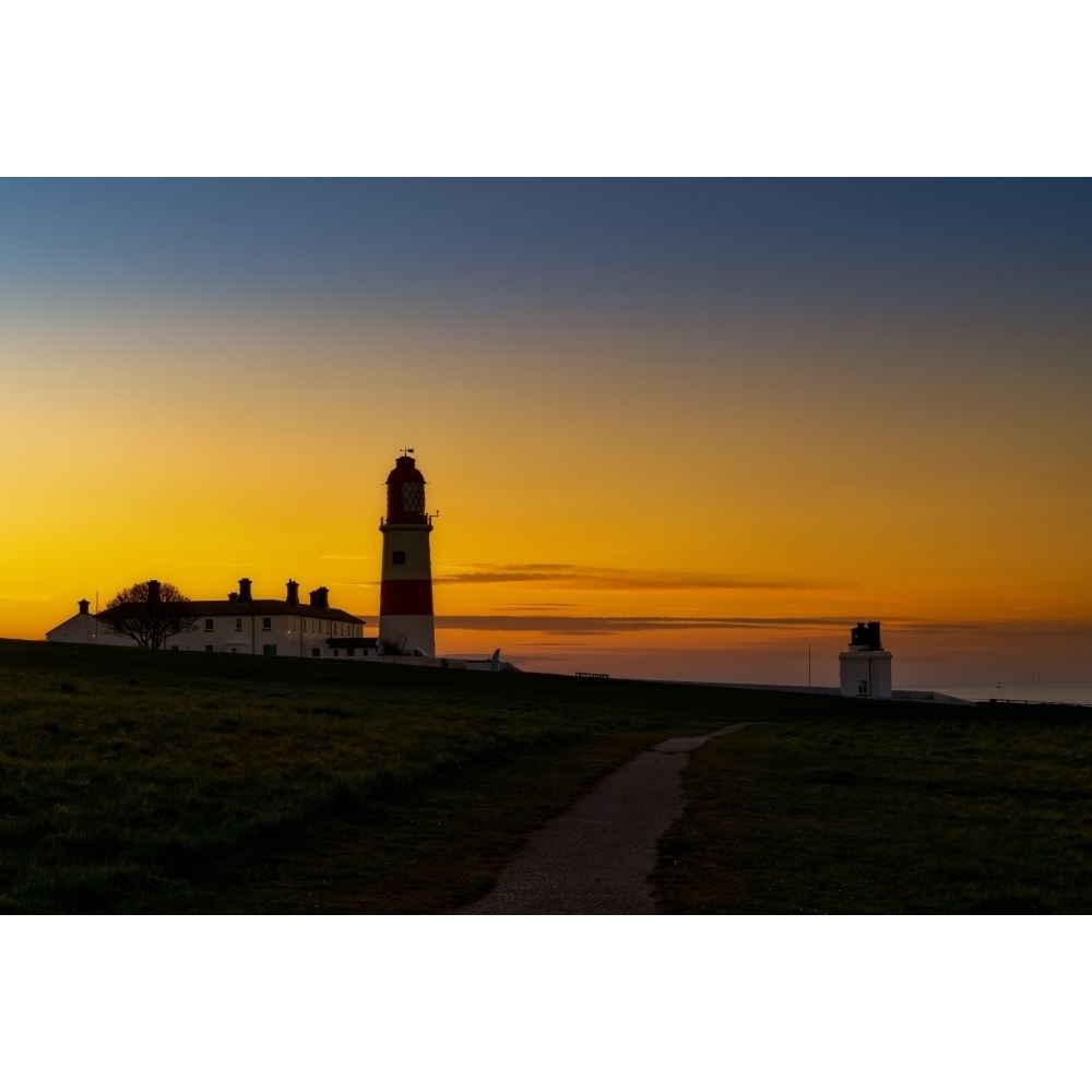 Souter Lighthouse at sunset with glowing orange and gold sunset; South ...
