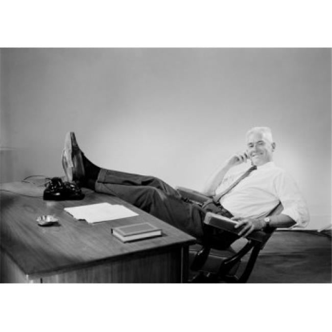 Superstock SAL255419040 Senior Businessman Sitting Behind Desk with ...