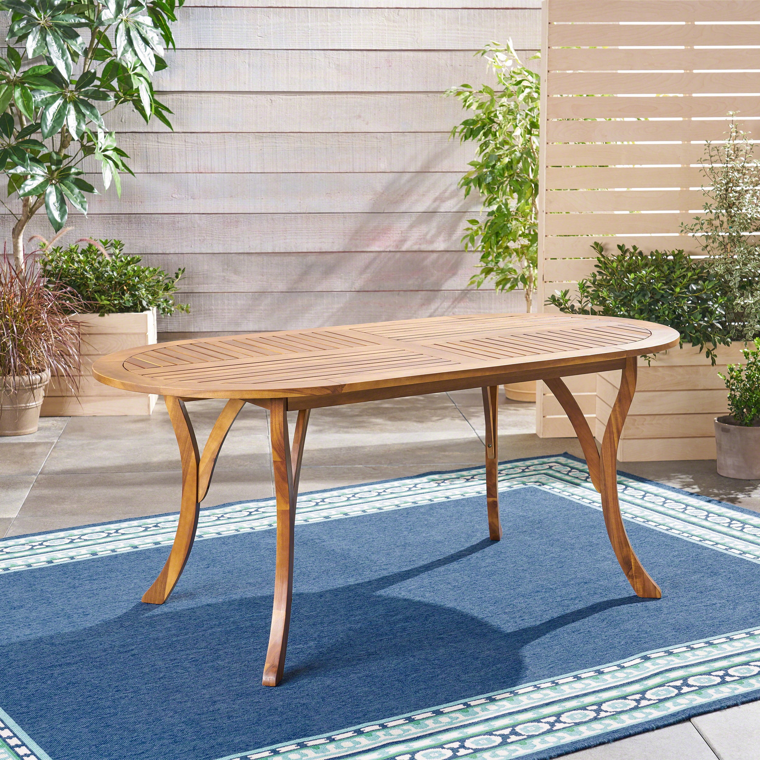 The outdoor Acacia 70-inch dining table, oval table with a beautiful ...