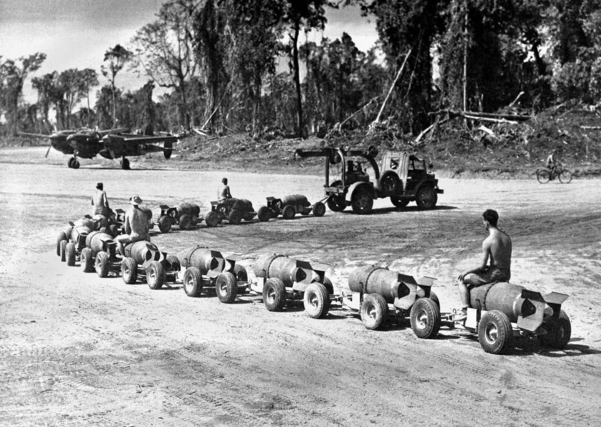 Three U.S. Marines Ride On A Truck Drawn Bomb Train At A Pacific Air ...