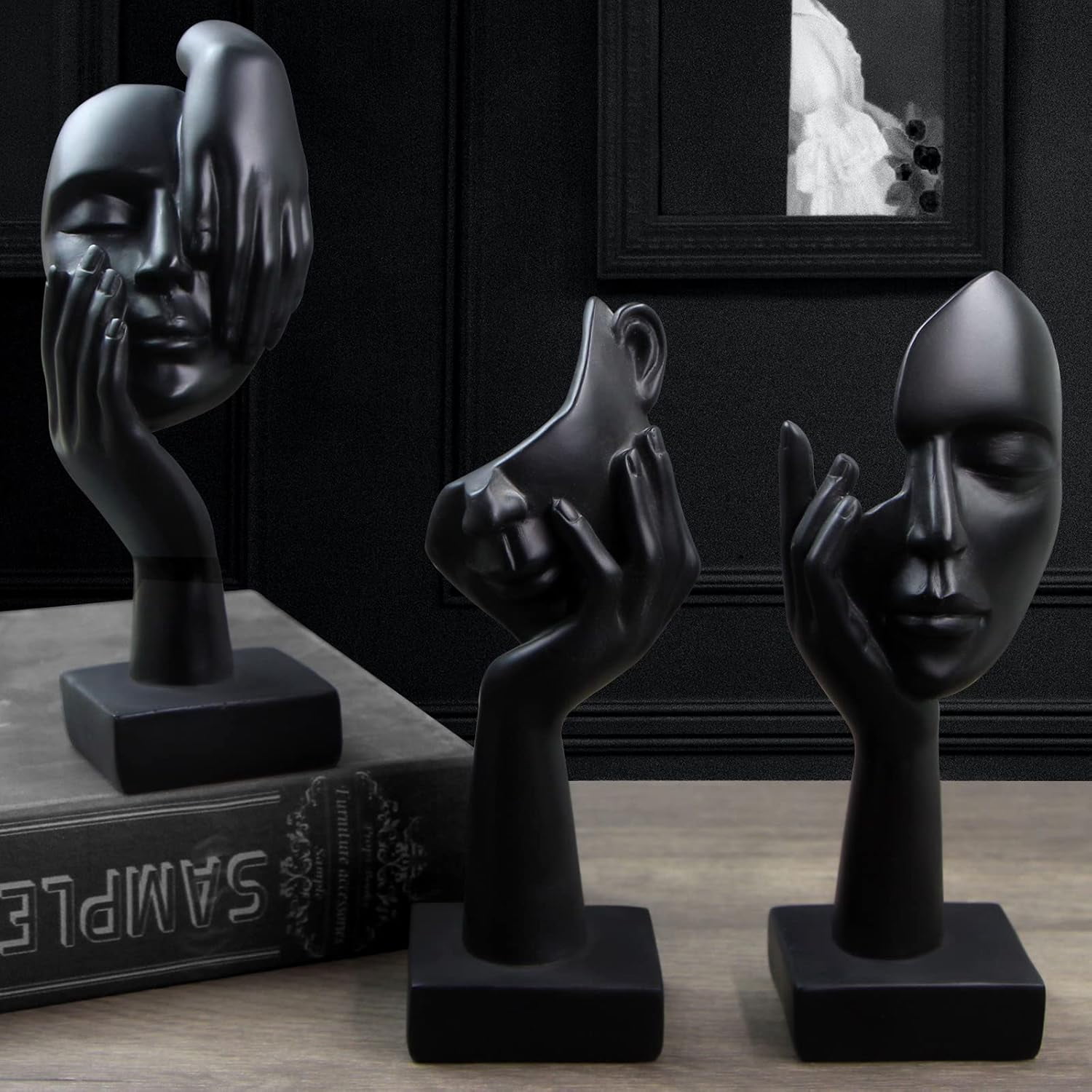 Three statues of thinkers, a silent gold abstract art statue, and a ...