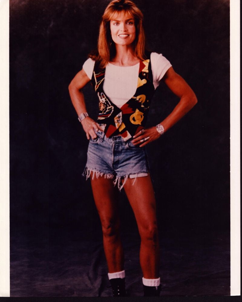 Tracy Scoggins In Shorts And Patterned Vest With Hands On Hips Photo ...