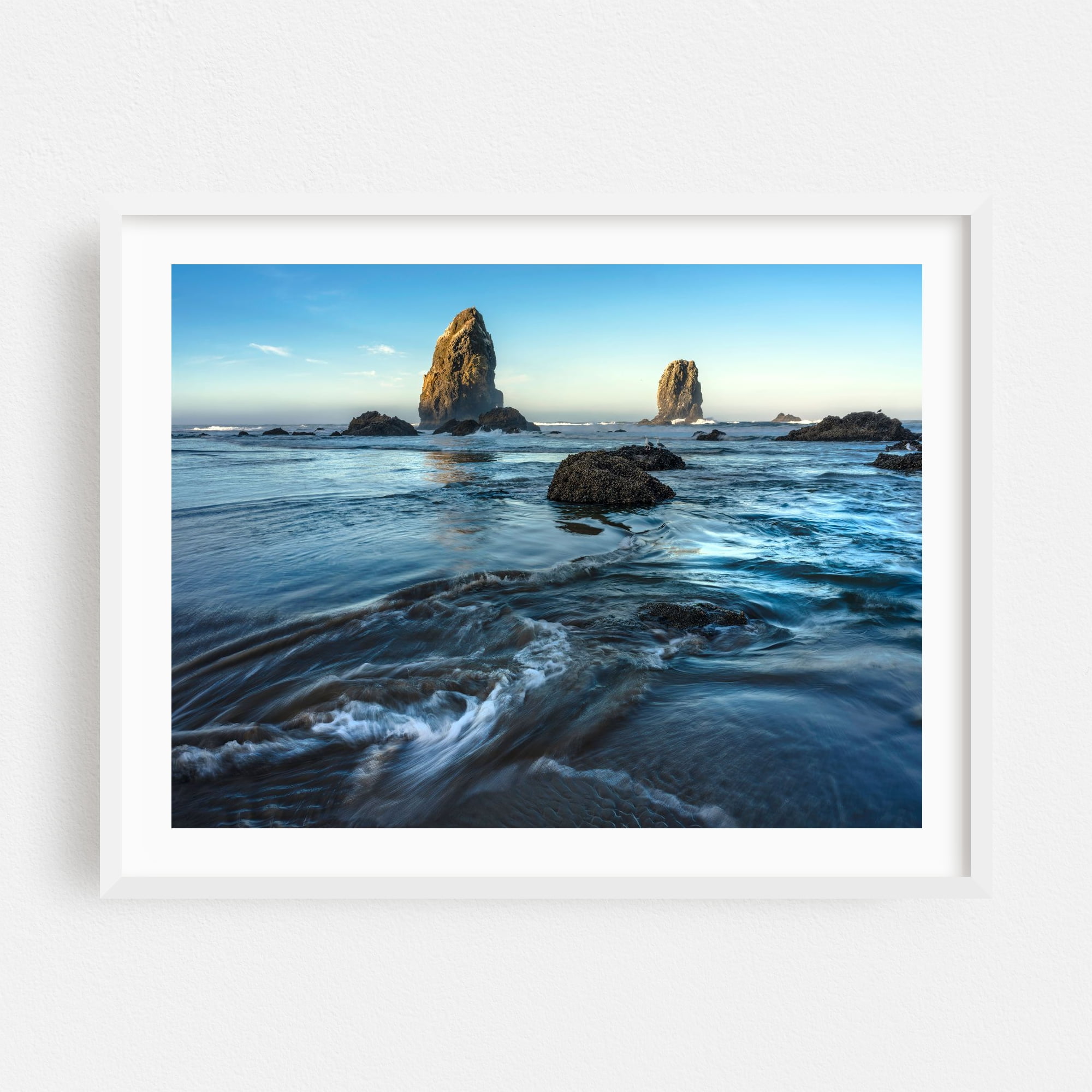 Tranquil waves flow around striking coastal rock formations - Cannon ...