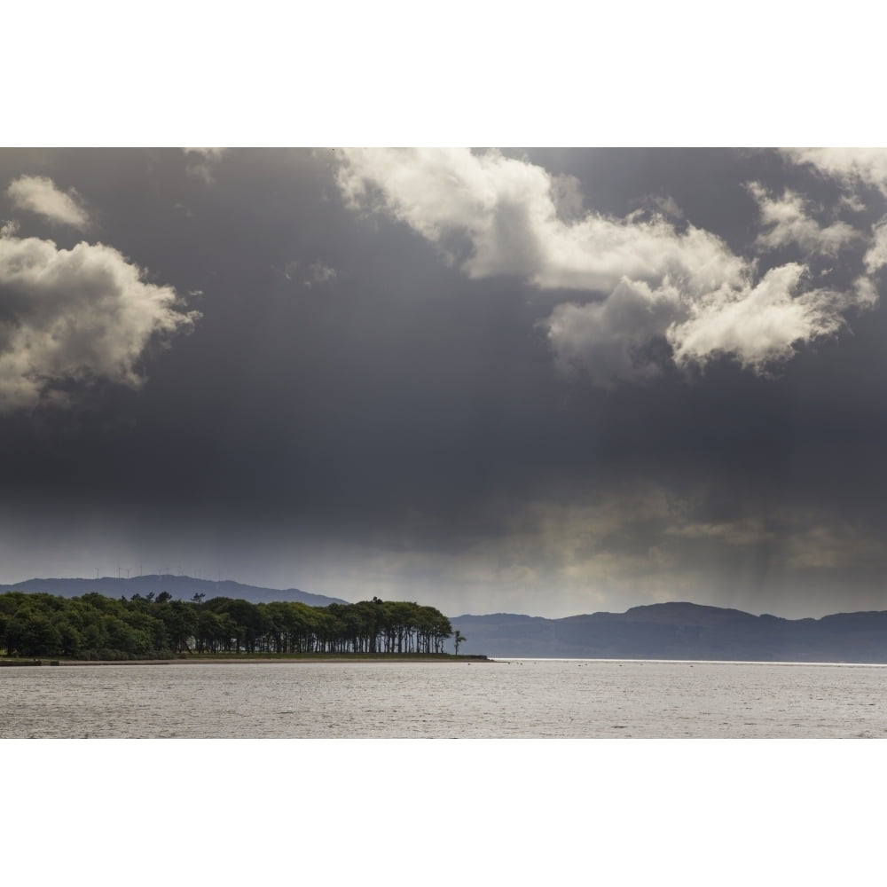 Trees and mountains along the coastline under storm clouds; Otter Ferry ...