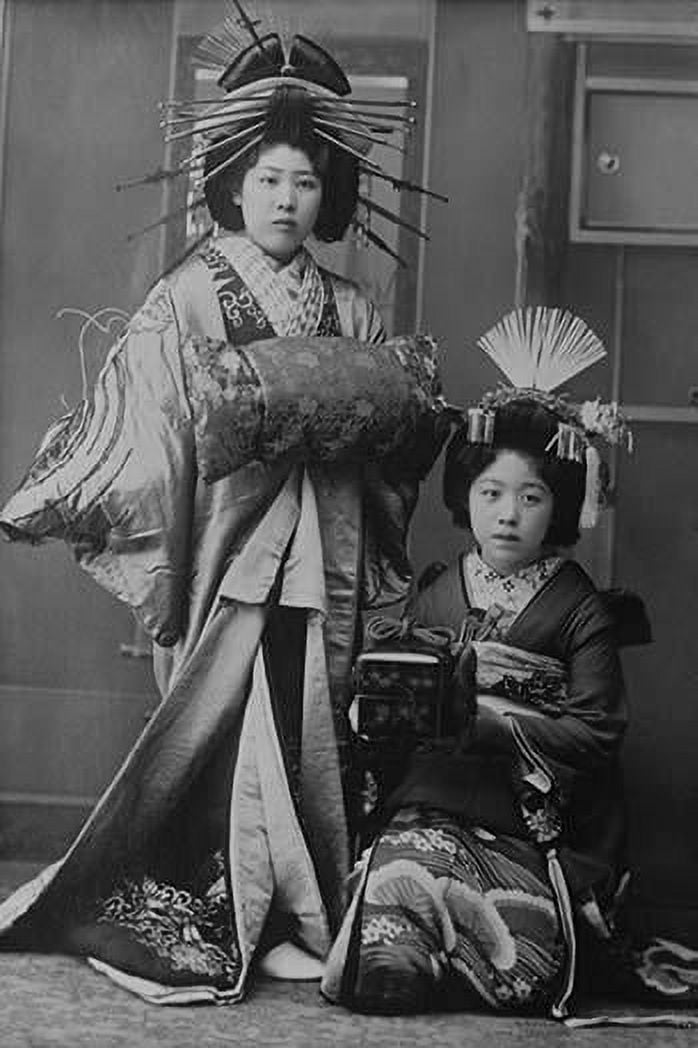 Two Young Beautiful Japanese Geishas accoutered in the ceremonial ...