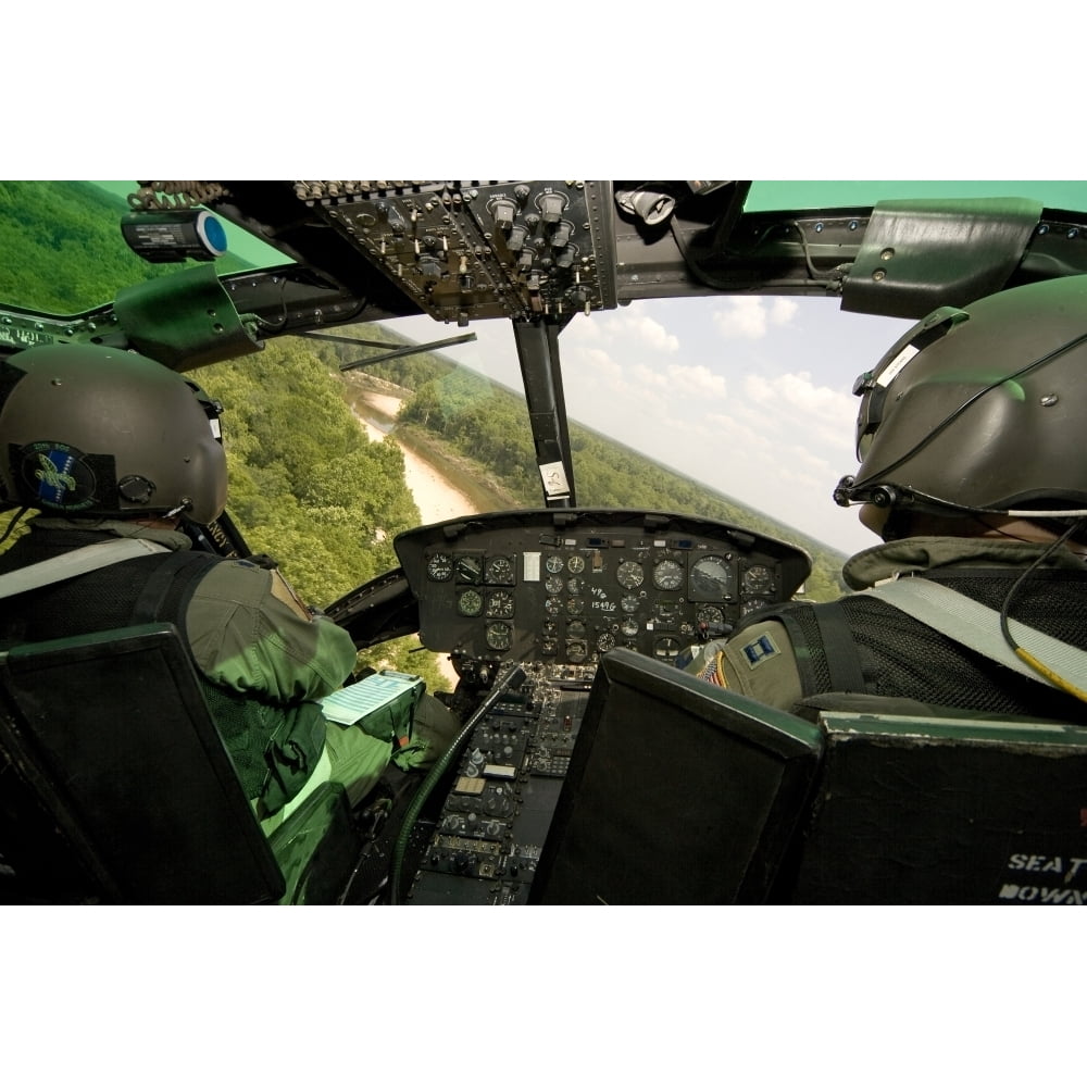 Two instructor pilots practice low flying operations in a UH-1H Huey ...
