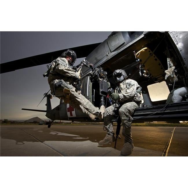 U.S. Army crew strapped into the medevac hoist of a UH-60L Black Hawk ...
