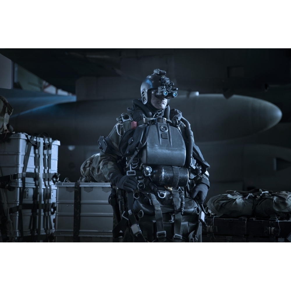 U.S. Navy Seal equipped with night vision prepares for HALO jump ...